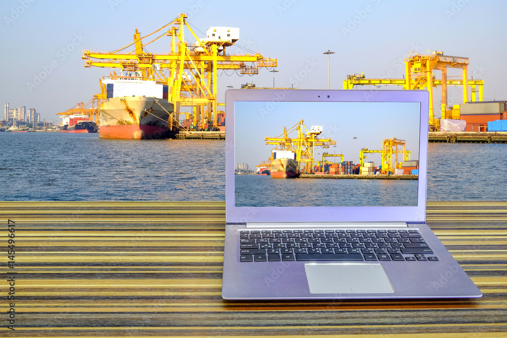 Laptop with logistic system screen on long table with logistic ...