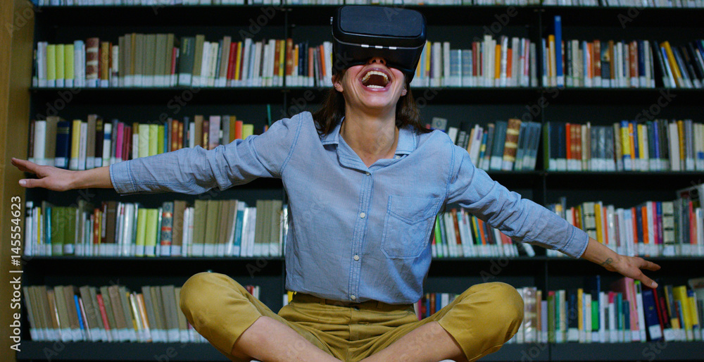 A beautiful young woman in a library travels in a virtual futuristic ...