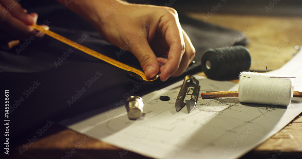 Fotografia do Stock: Slow motion sew of a hand of a young tailor who ...
