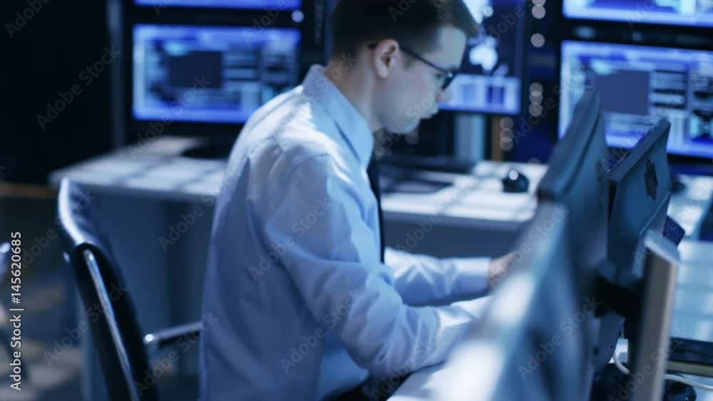 In Monitoring Room System Engineers Working at Their Workstation ...