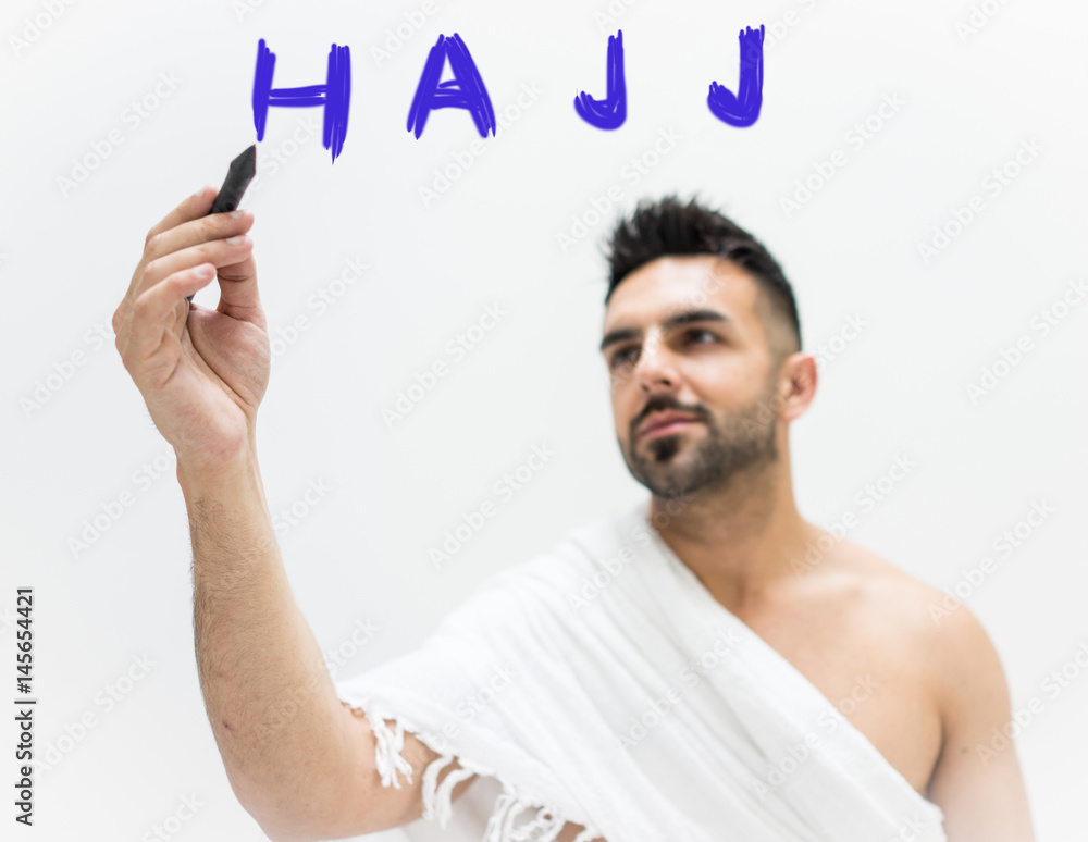 Muslim man posing as ready for Hajj visiting Kaaba in Mecca writing ...