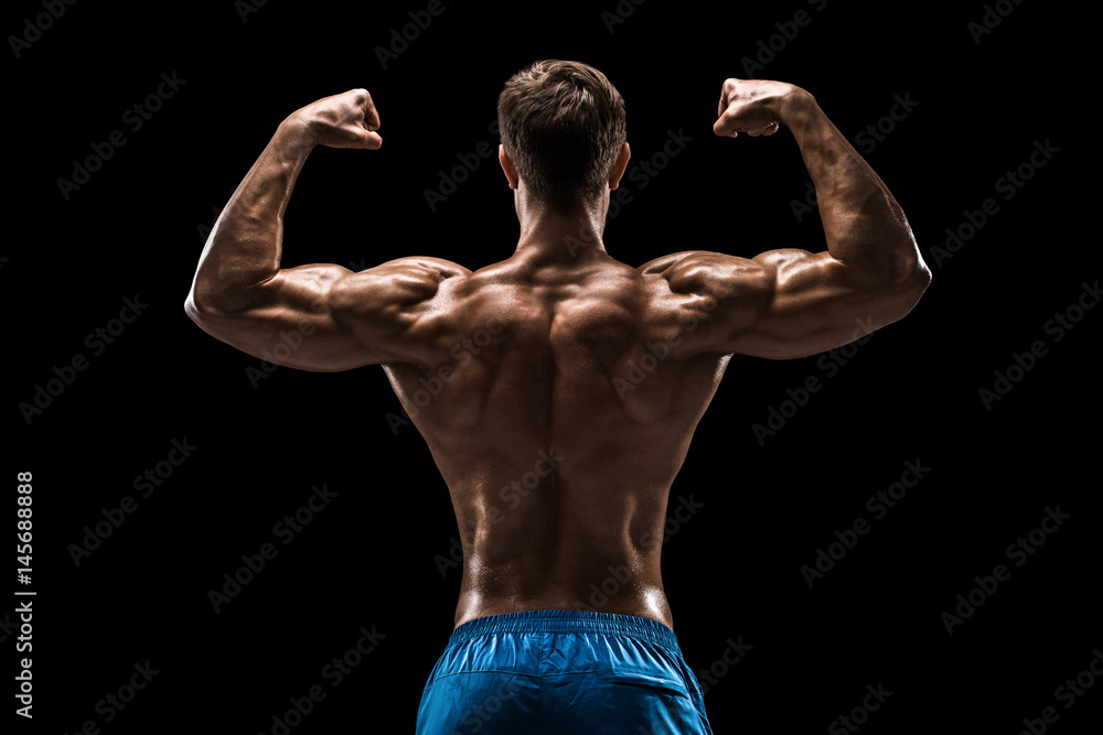 Strong Athletic Man Fitness Model posing back muscles, triceps over ...