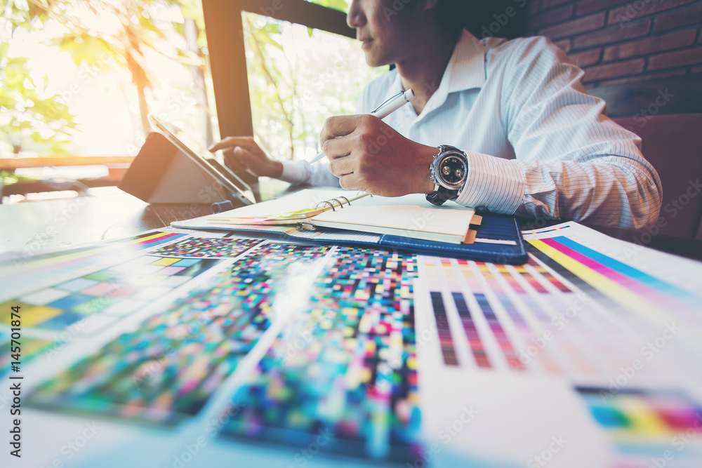 designer man working graphic with color chart and write short note for ...