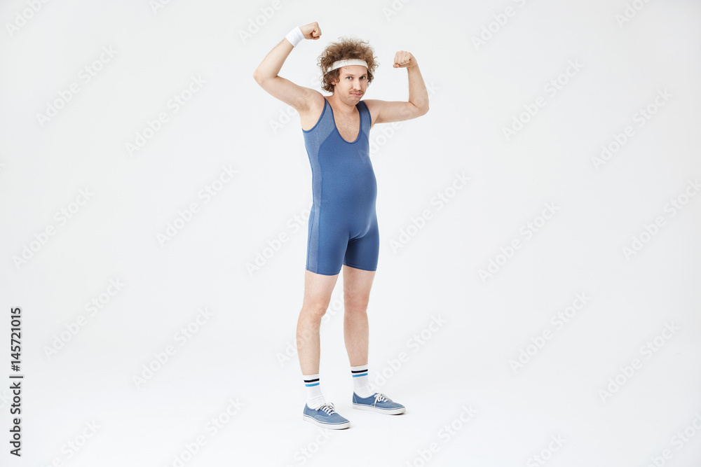 Weak man with belly showing muscles, posing in sport jumpsuit Stock ...