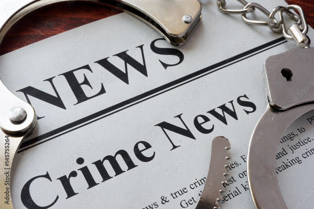 Newspaper with title crime news and handcuffs. Stock Photo | Adobe Stock