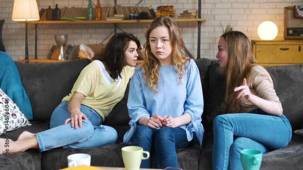 young girl is unhappy, sad and depressed because her bad female friends ...