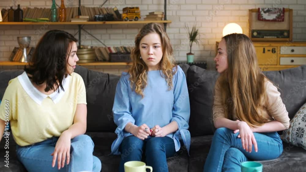 young girl is unhappy, sad and depressed because her bad female friends ...