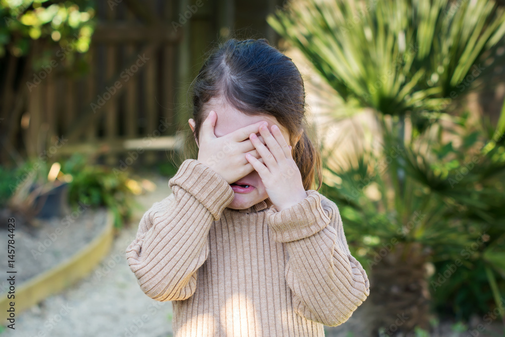 Little girl crying in the garden Stock Photo | Adobe Stock