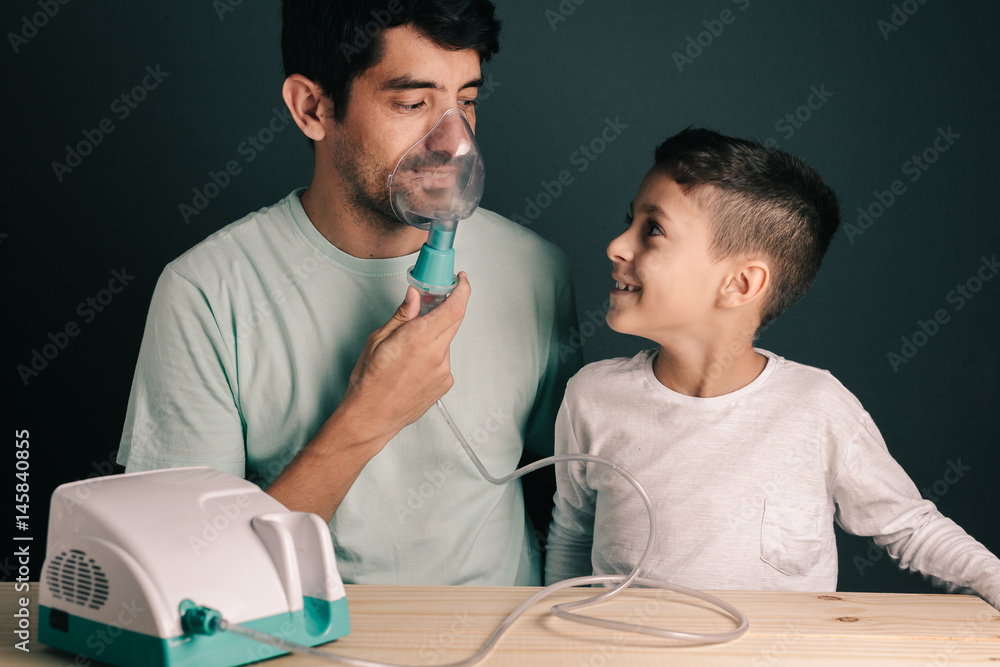 Portrait of father and son using domestic inhaler / nebulizer Stock ...