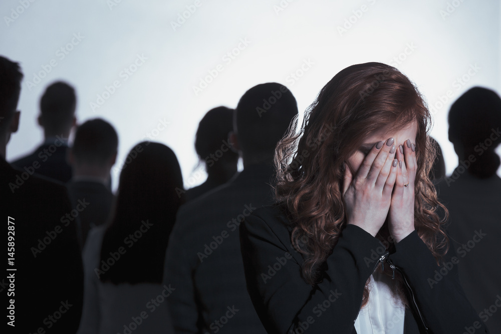 Woman crying in crowd Stock 写真 | Adobe Stock