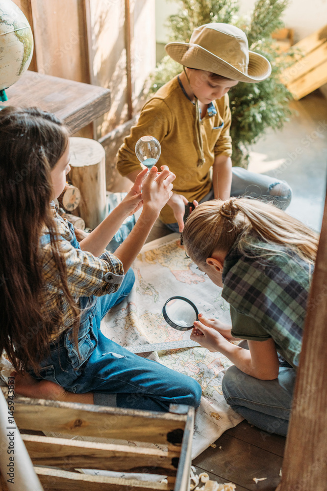 cute kids playing treasure hunt with map on porch Stock Photo | Adobe Stock