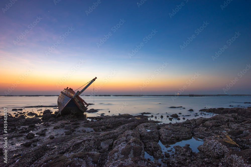 Fishing boat aground on the rocks for a long time at sea erosion ...