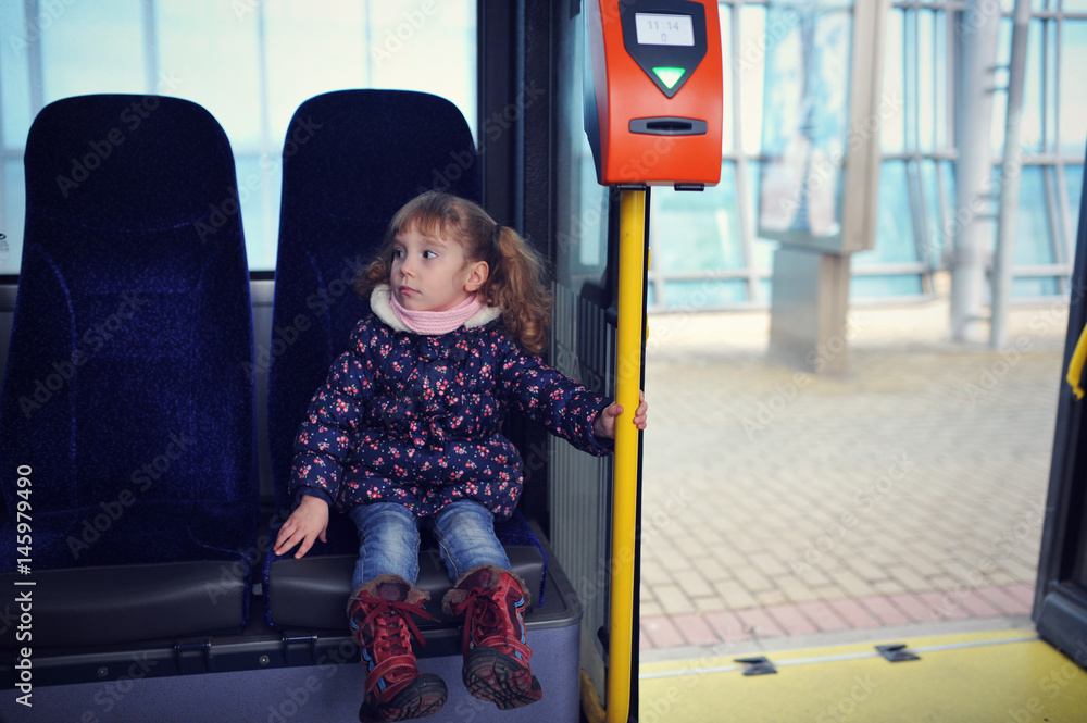 Little girl in Prague public transport - sitting on the seat in bus ...