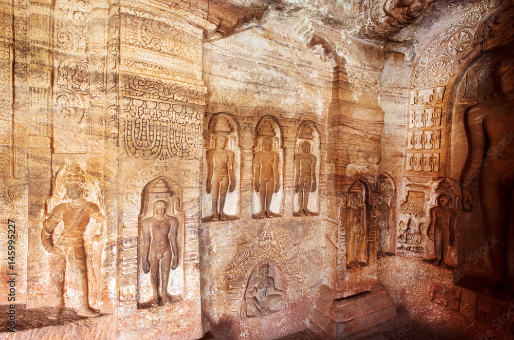 Indian rock-cut architecture. Carved wall dedicated to revered figures ...