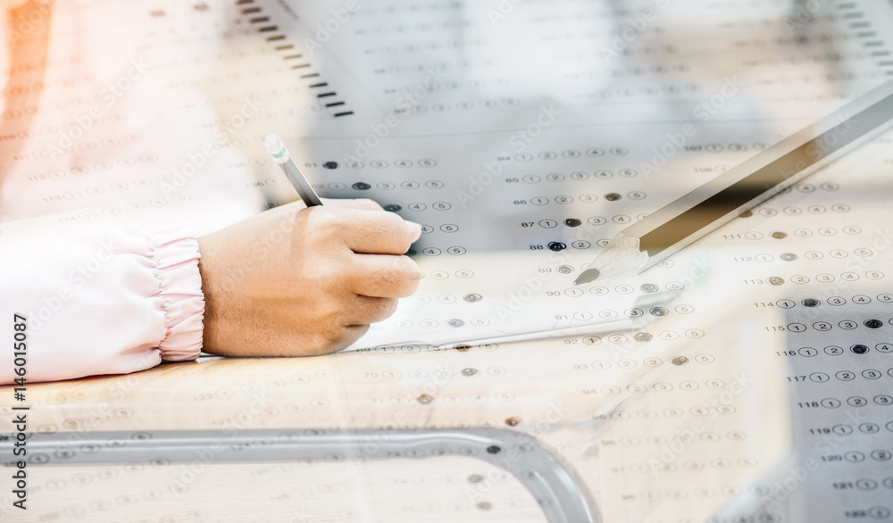 Student hand holding pencil writing doing examination and exams answer ...