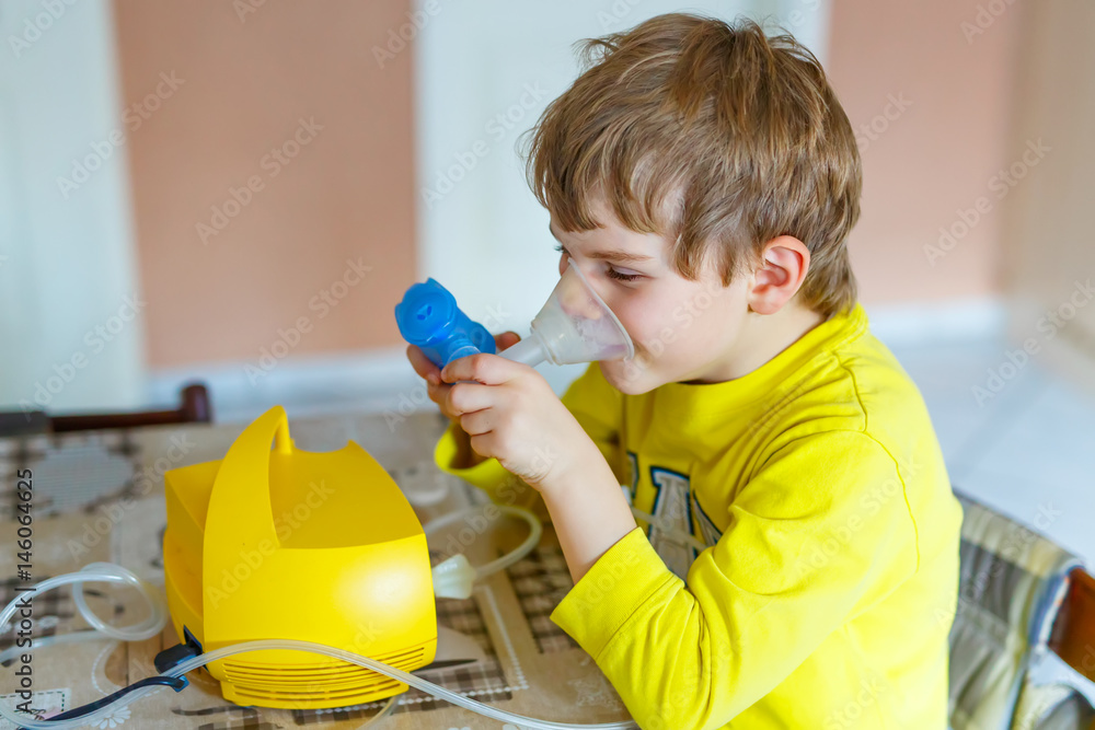 Cute kid boy making inhalation therapy by the mask of inhaler Stock ...
