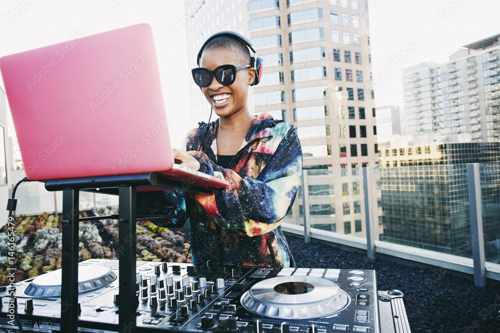 Smiling Black DJ on urban rooftop Stock Photo | Adobe Stock