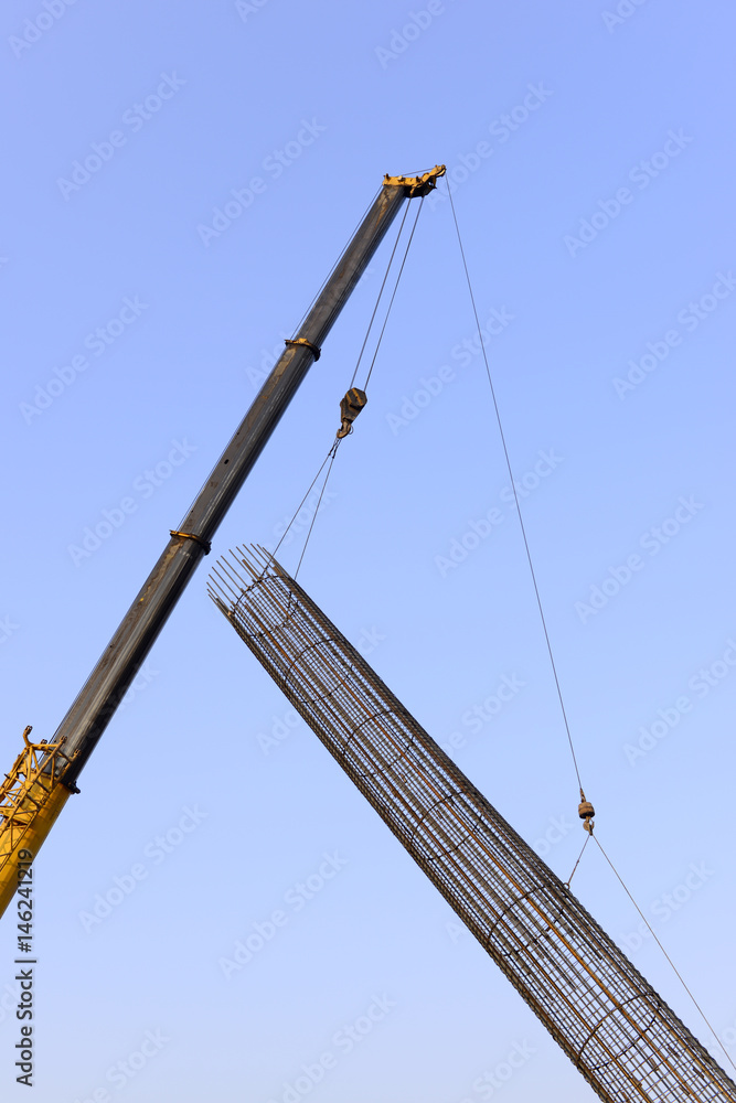 Hoisting steel bars in the construction site Stock Photo | Adobe Stock