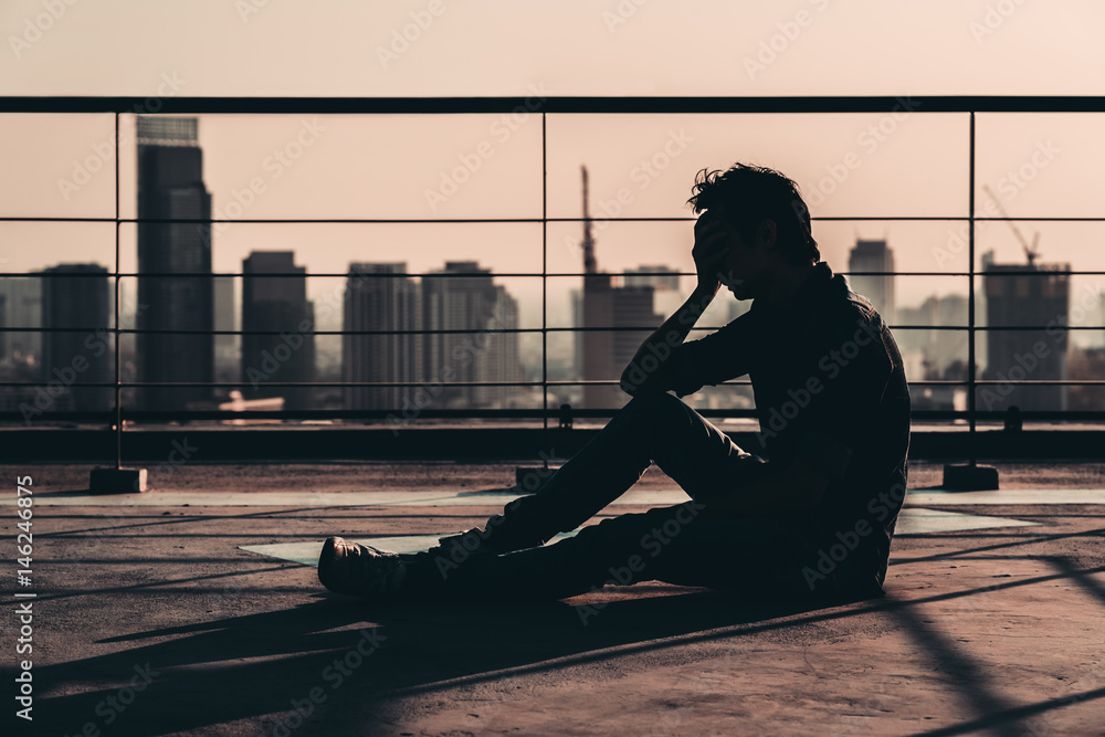 Silhouette of sad depressed Asian man lost hope and cry, sit on ...