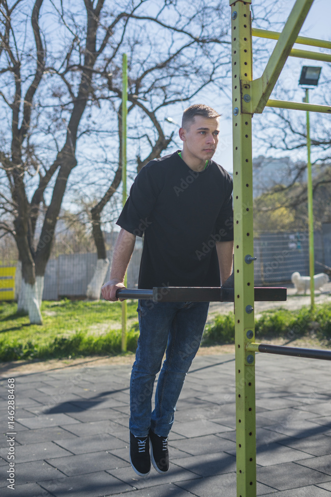Young Athlete doing a Hand Stand On Parallel Bars In An Outdoor Gym ...