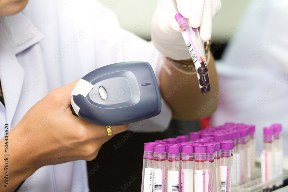 Doctor scanning data from the blood sample in the tube. Loading bar ...