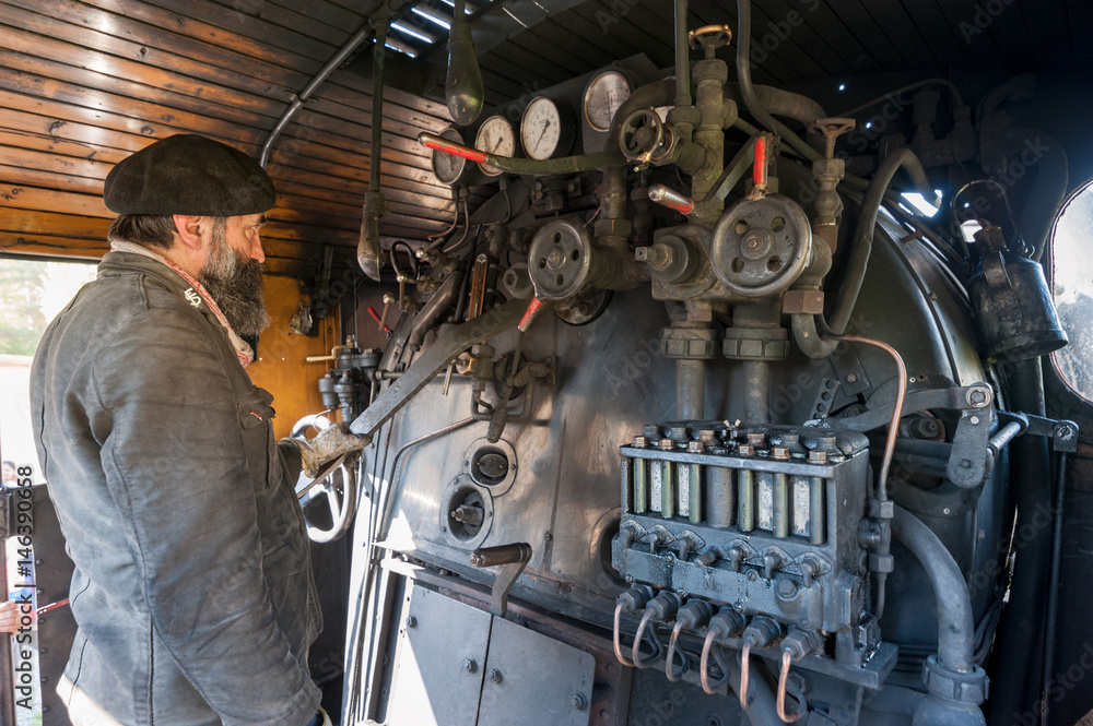 The train driver near the steam locomotive boiler Stock Photo | Adobe Stock