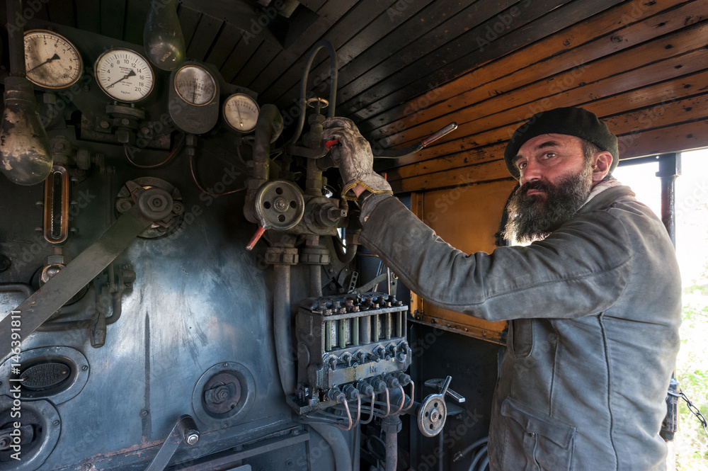 The train driver near the steam locomotive boiler Stock Photo | Adobe Stock