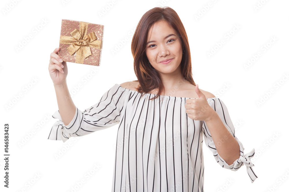Young Asian woman thumbs up with a gift box. Stock Photo | Adobe Stock