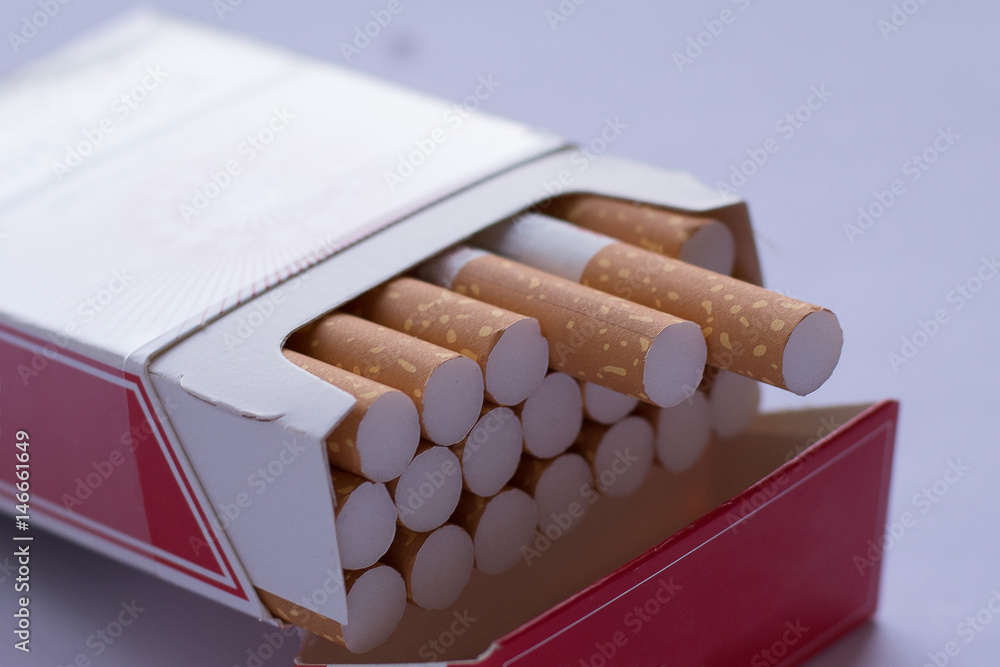 Cigarettes in an open red and white pack on a light table Stock Photo ...