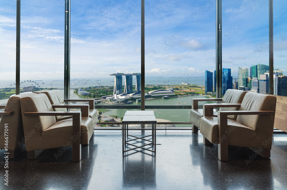 Luxury hotel lounge with windows overlooking city in Singapore. Marina ...