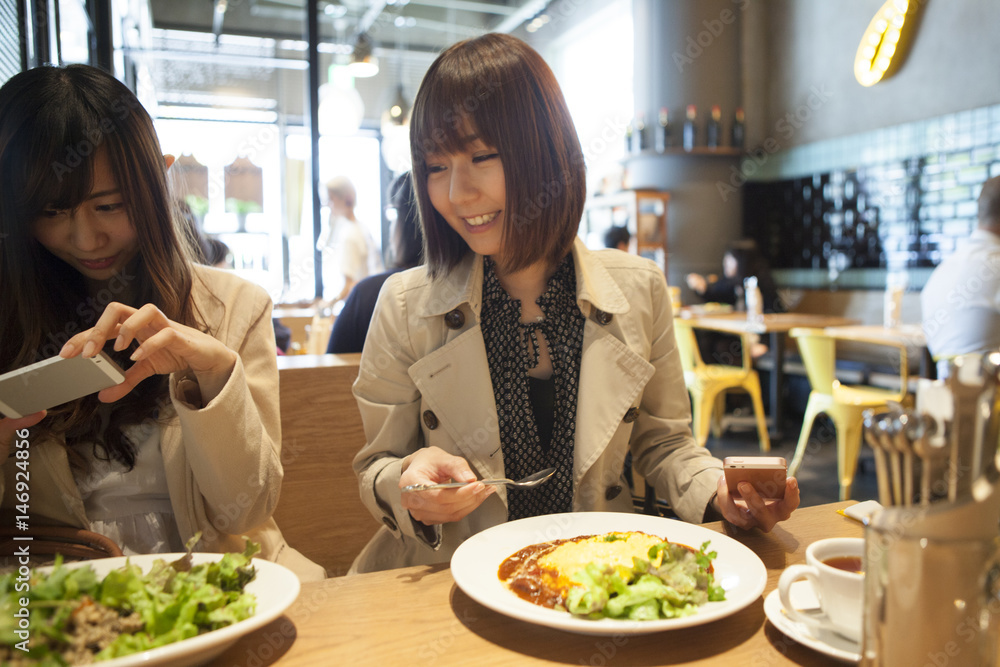 Women are shooting lunch with a smartphone Stock Photo | Adobe Stock