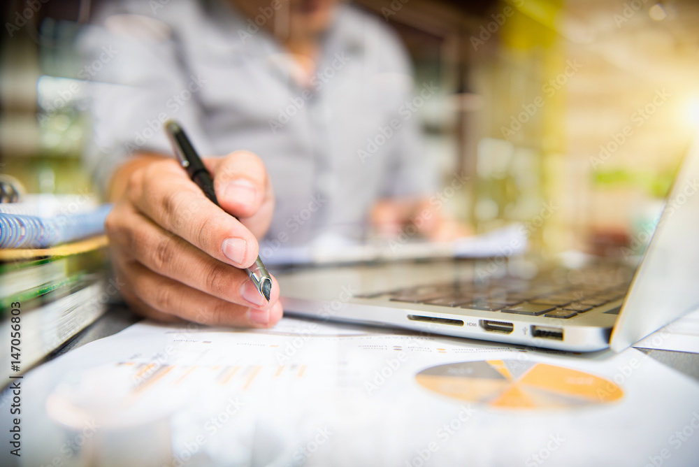 Businessman making presentation on office table with smart phone and ...