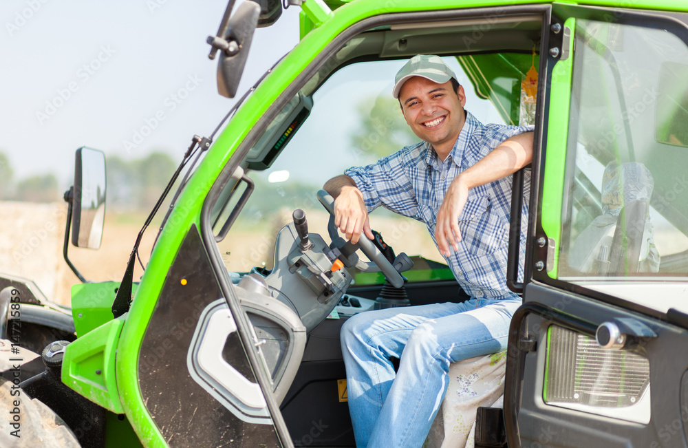 Portrait of a smiling farmer in his tractor Stock Photo | Adobe Stock
