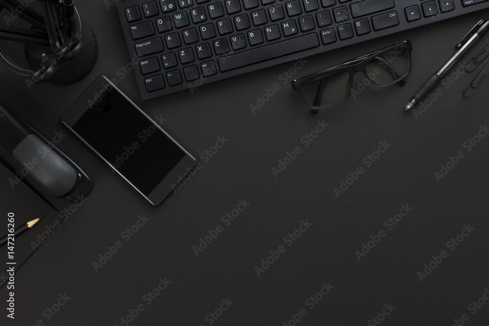 Top view of pitch black office desk with computer and supplies Stock ...