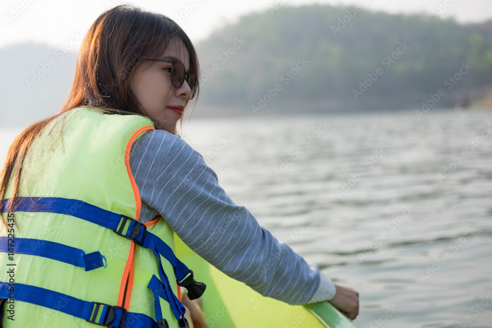 young woman equip life jacket sitting relaxing on prow. she looking ...