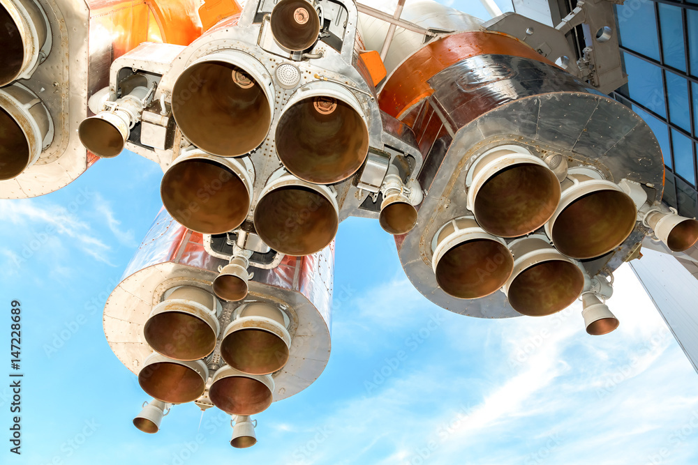 Space rocket engines of the russian spacecraft over blue sky background ...