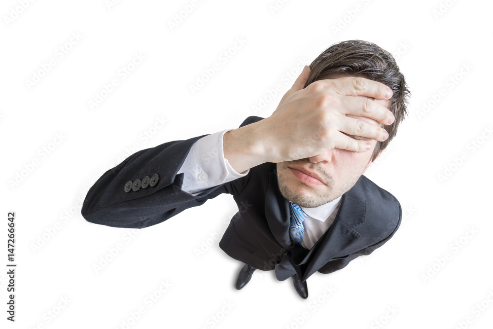 Young unhappy and stressed man made mistake and is covering his face ...