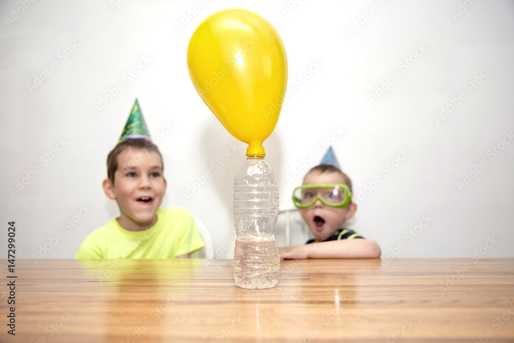 Two boys watching a chemistry experiment. children are surprised ...