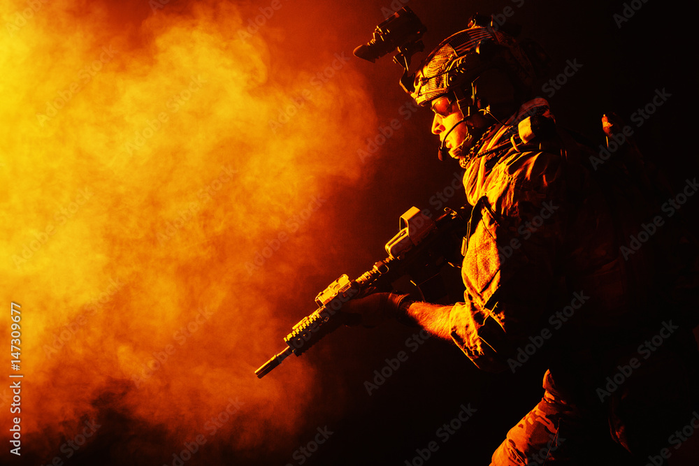 Security forces operator in Combat Uniforms with rifle, in the face of ...