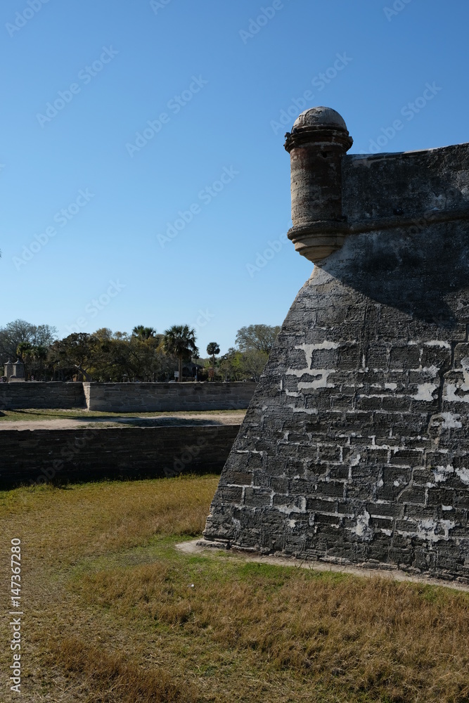 Edge of Castillo de San Marcos, green grass and former moat of fortress ...