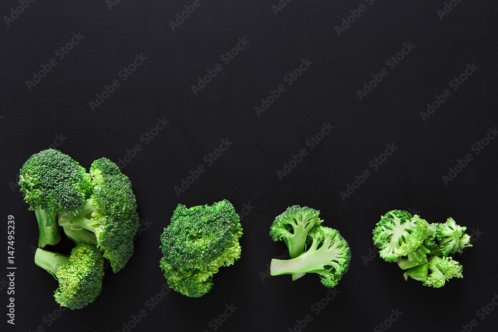 Stages of cutting broccoli on black background Stock Photo | Adobe Stock