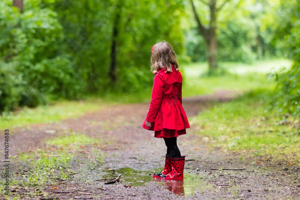 Little girl walking in the rain Stock Photo | Adobe Stock