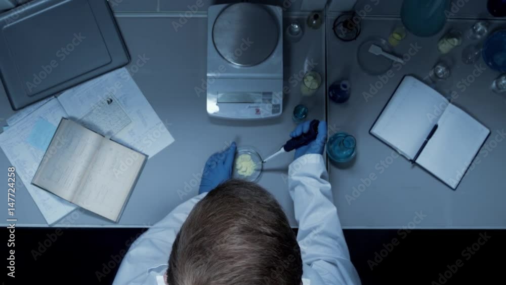 Laboratory technician injecting liquid into a microtiter plate. the ...