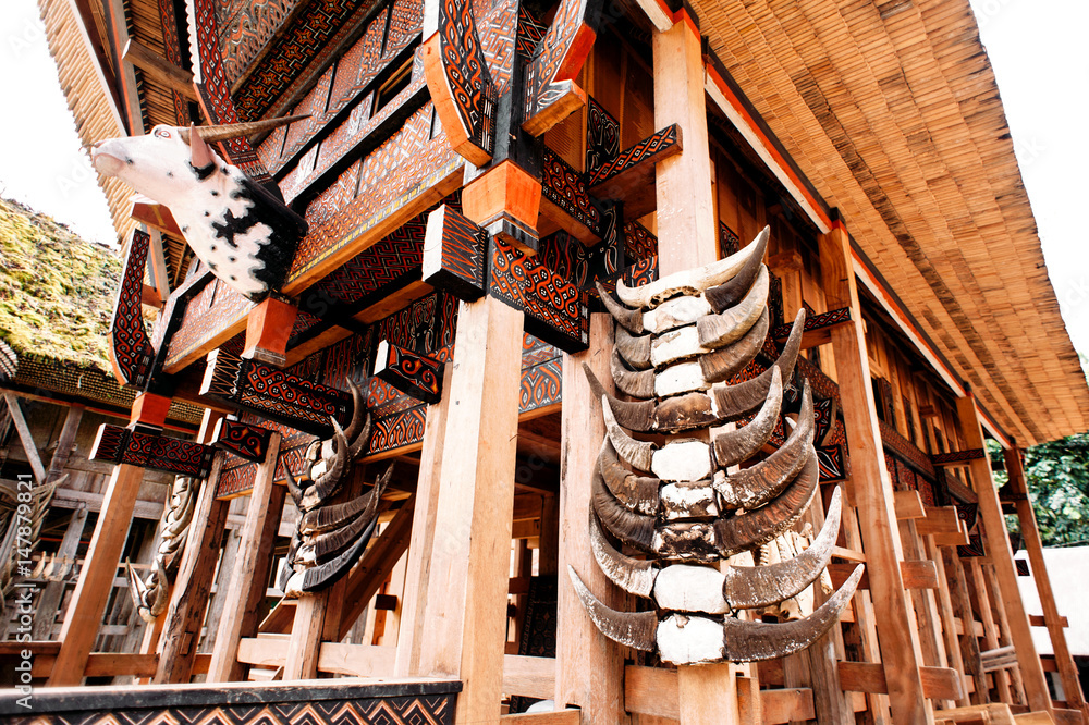Part of tongkonan house with horns of buffaloes and wood carving and ...