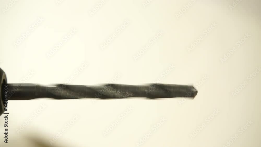 Close up view of spinning metal drill bit. Dolly sliding shot 4K ProRes ...