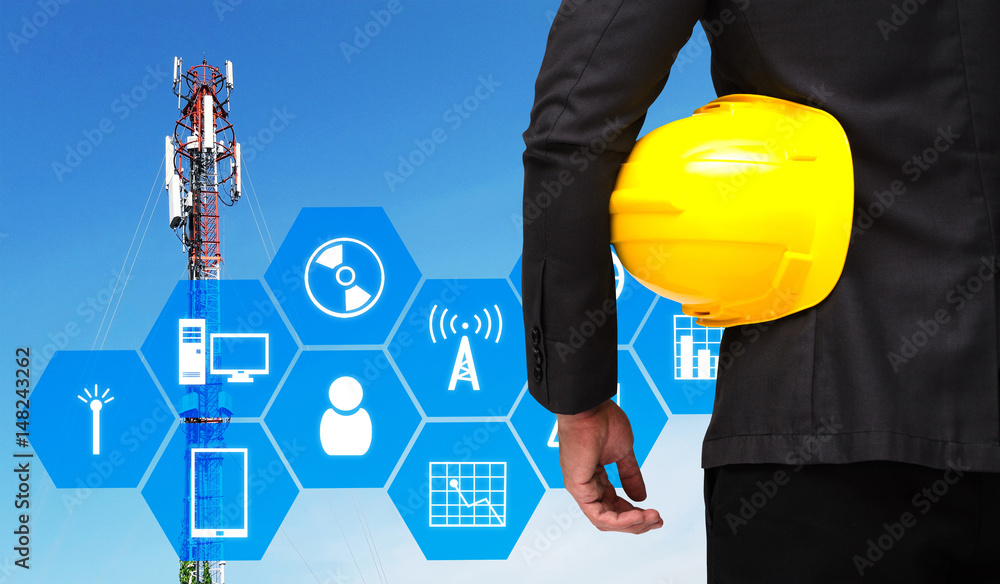 businessman with yellow safety helmet with technology device icon and ...