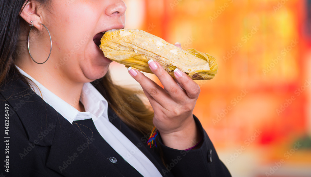 Gorgeous woman eating a delicious humita, traditional andean food ...