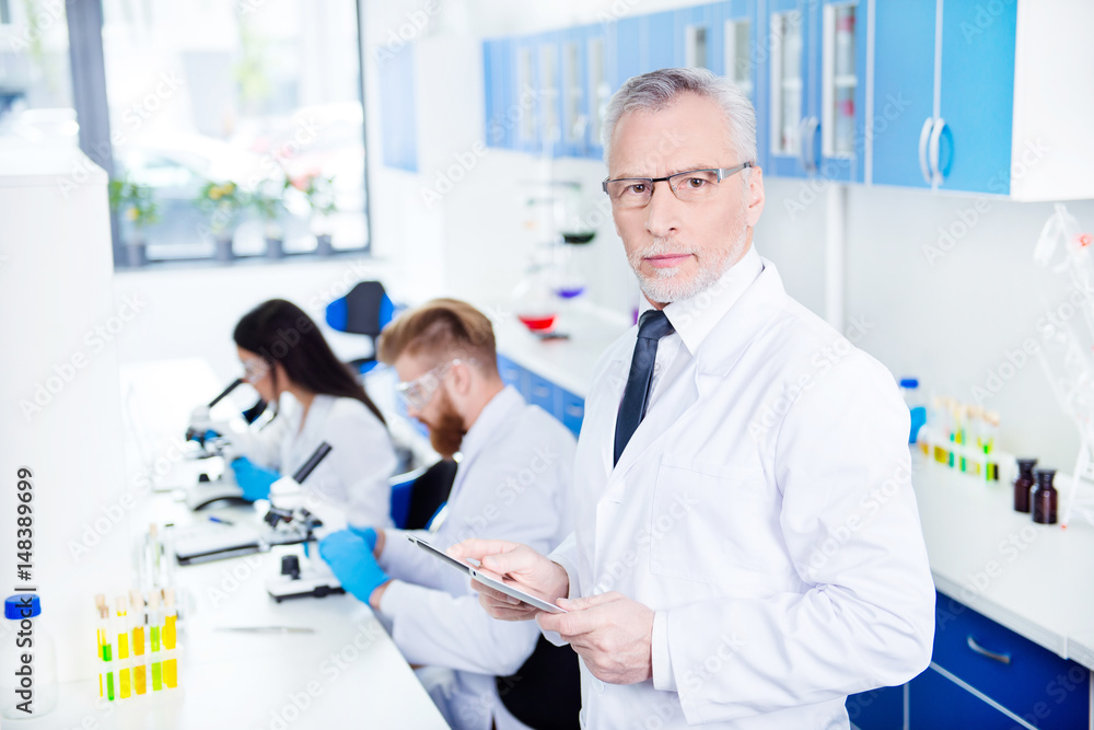 Laboratory work of three. Close up portrait of professor in formal wear ...