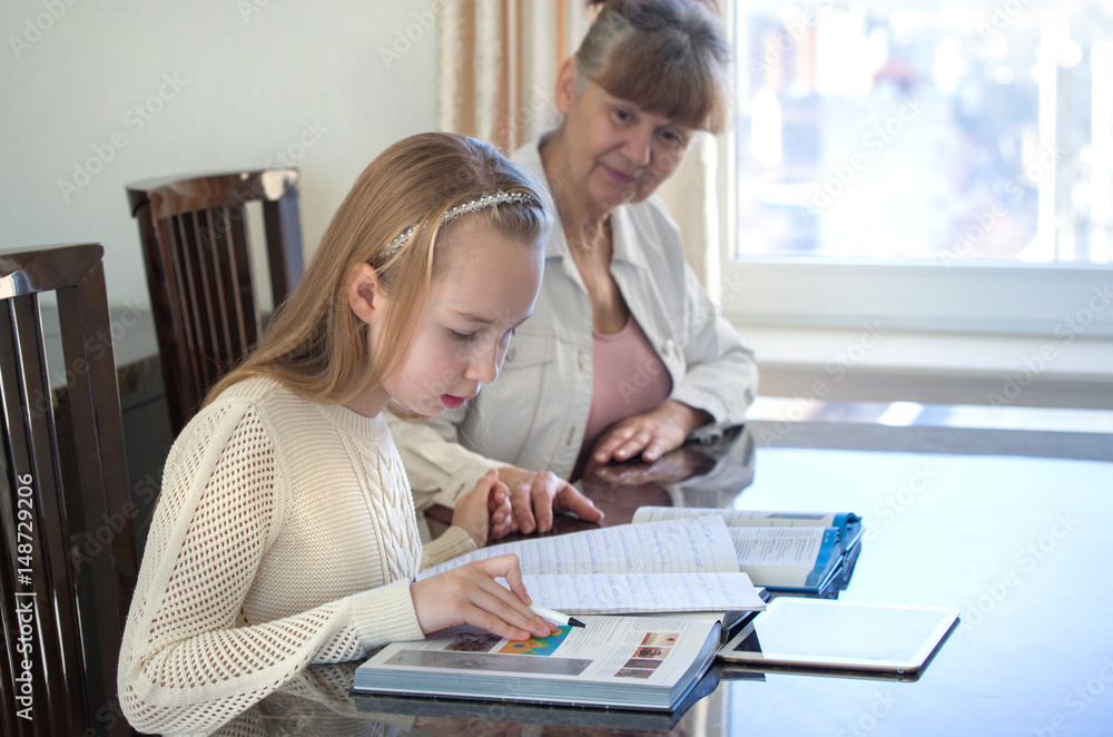10 years old girl and her teacher. Little girl study during her private ...