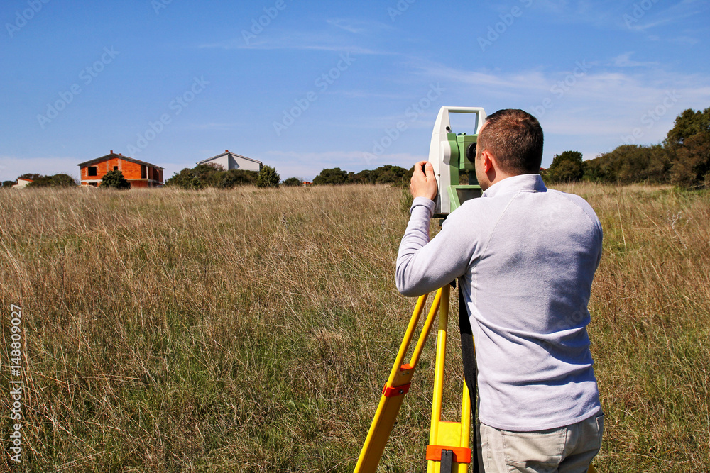 Man using of total station. Guy surveyor at work. Survey Instrument ...